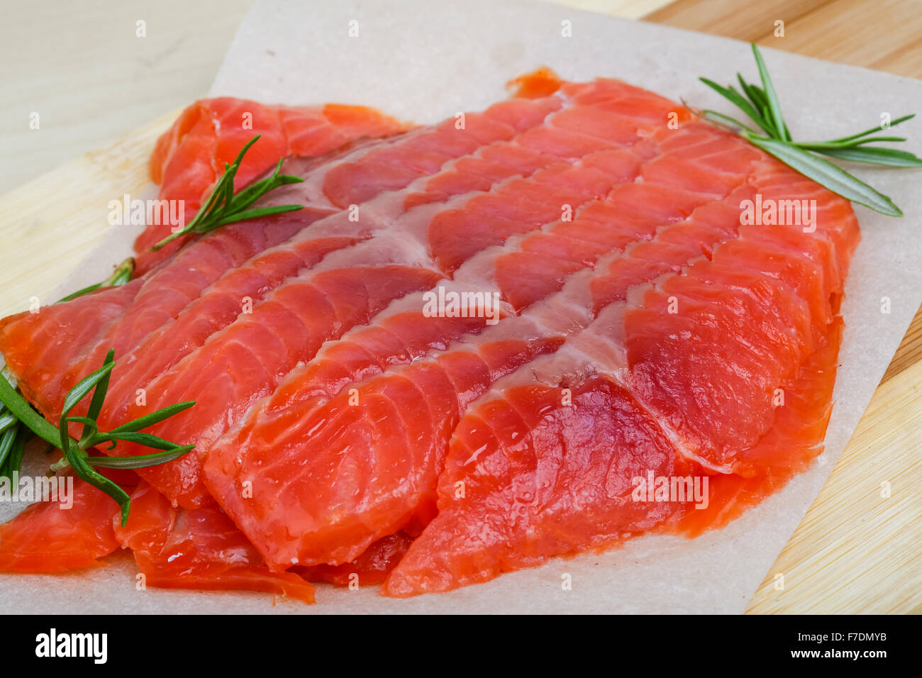 Sliced sashimi with rosenary leaves on the wood background Stock Photo ...