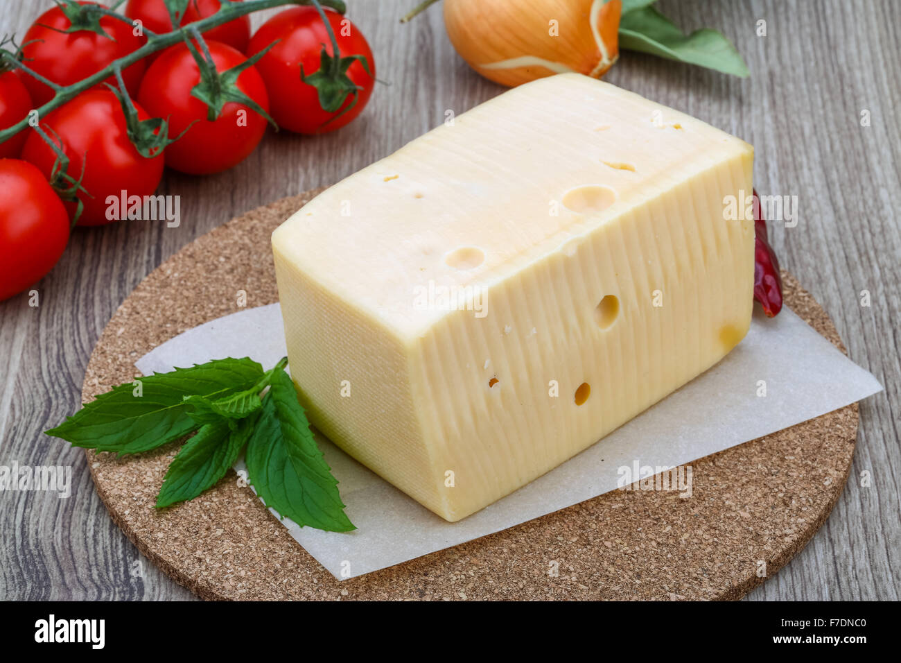 Yellow cheese brick with mint leaves on the wood background Stock Photo ...