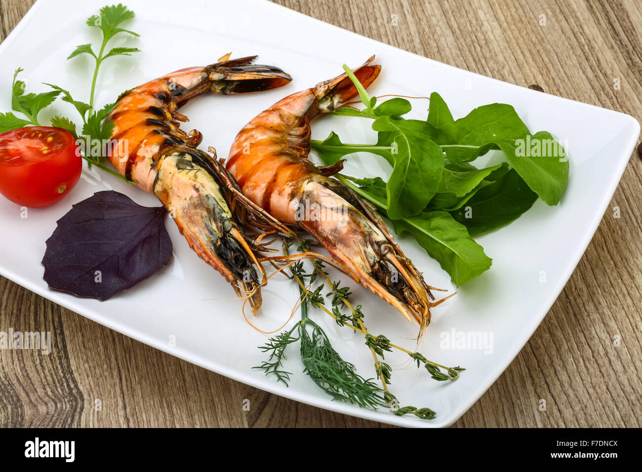 Roasted tiger shrimps with thyme and basil leaves Stock Photo - Alamy