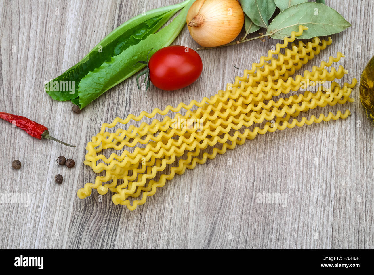 Long raw fusilli with olive oil and spices Stock Photo - Alamy