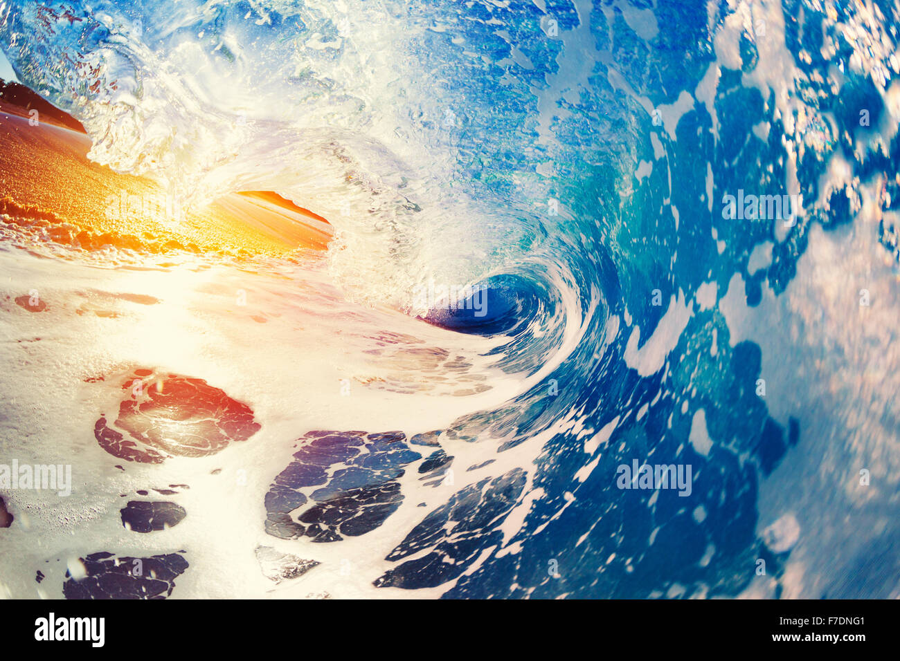 Blue Ocean Wave Crashing at Sunrise Stock Photo - Alamy