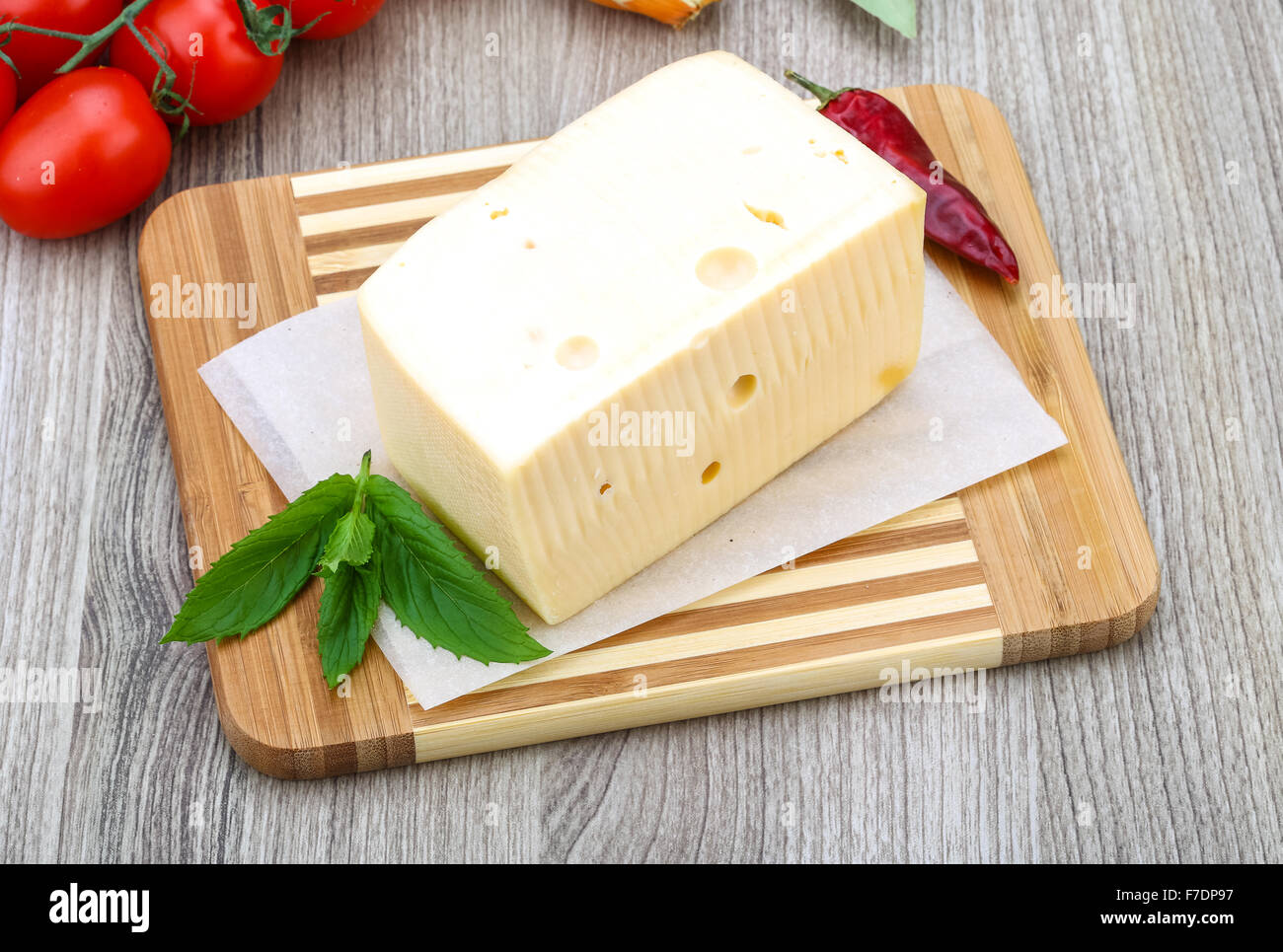 Cheese brick with mint leaves on the wood background Stock Photo - Alamy