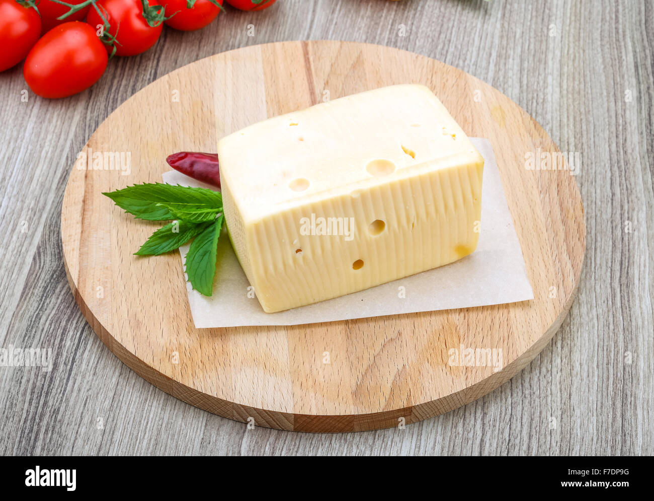 Yellow cheese brick with mint leaves on the wood background Stock Photo ...