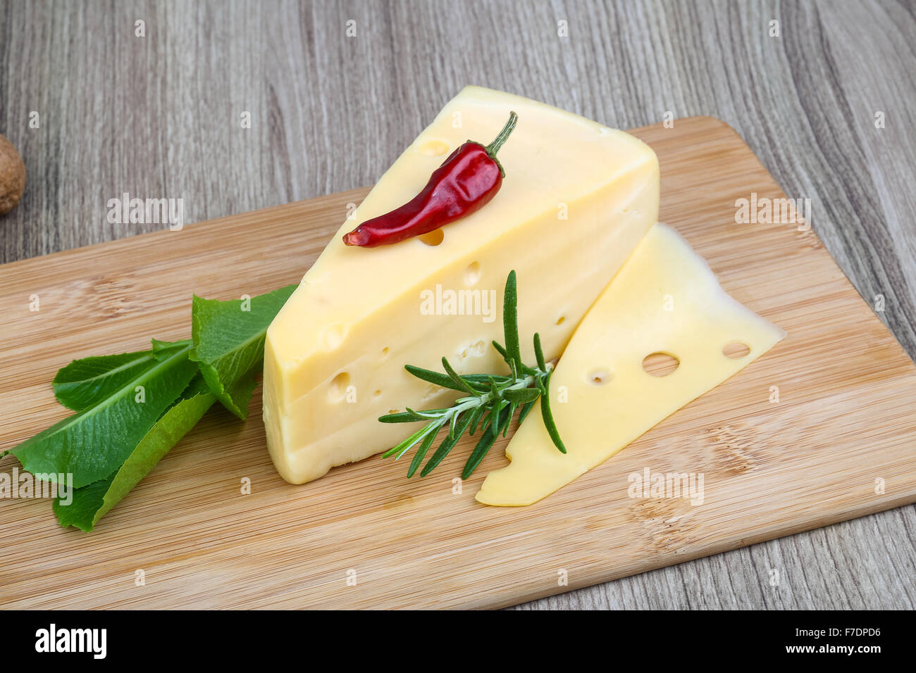 Yellow Cheese triangle with rosemary on the wood background Stock Photo ...