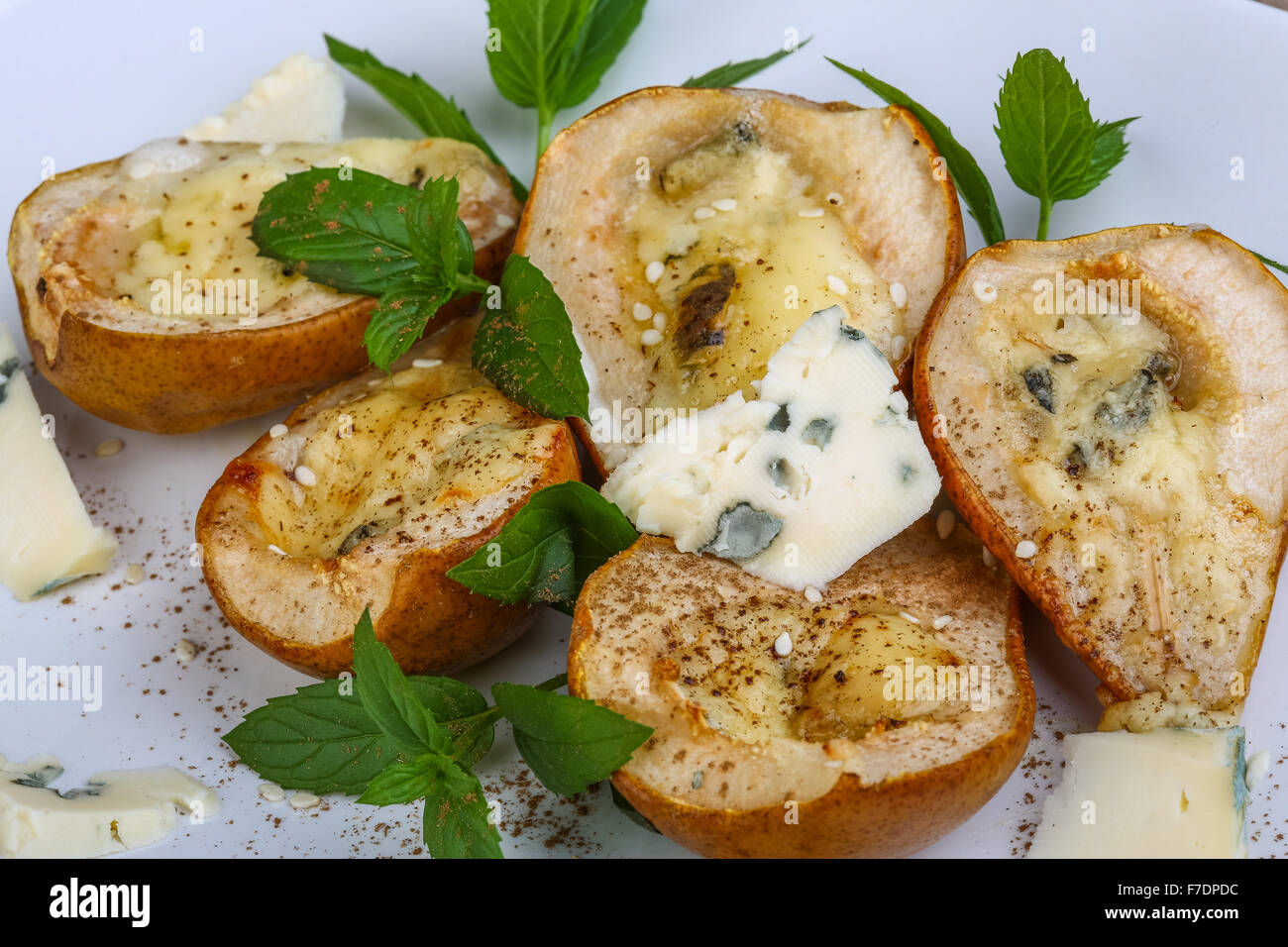Baked pear with blue cheese served mint leaves Stock Photo - Alamy