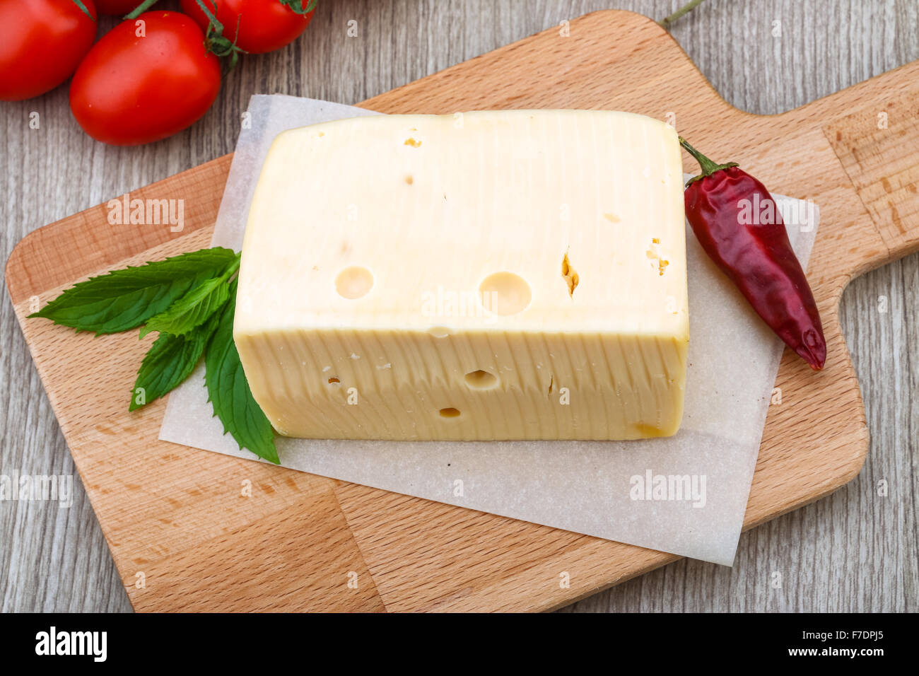 Yellow cheese brick with mint leaves on the wood background Stock Photo ...