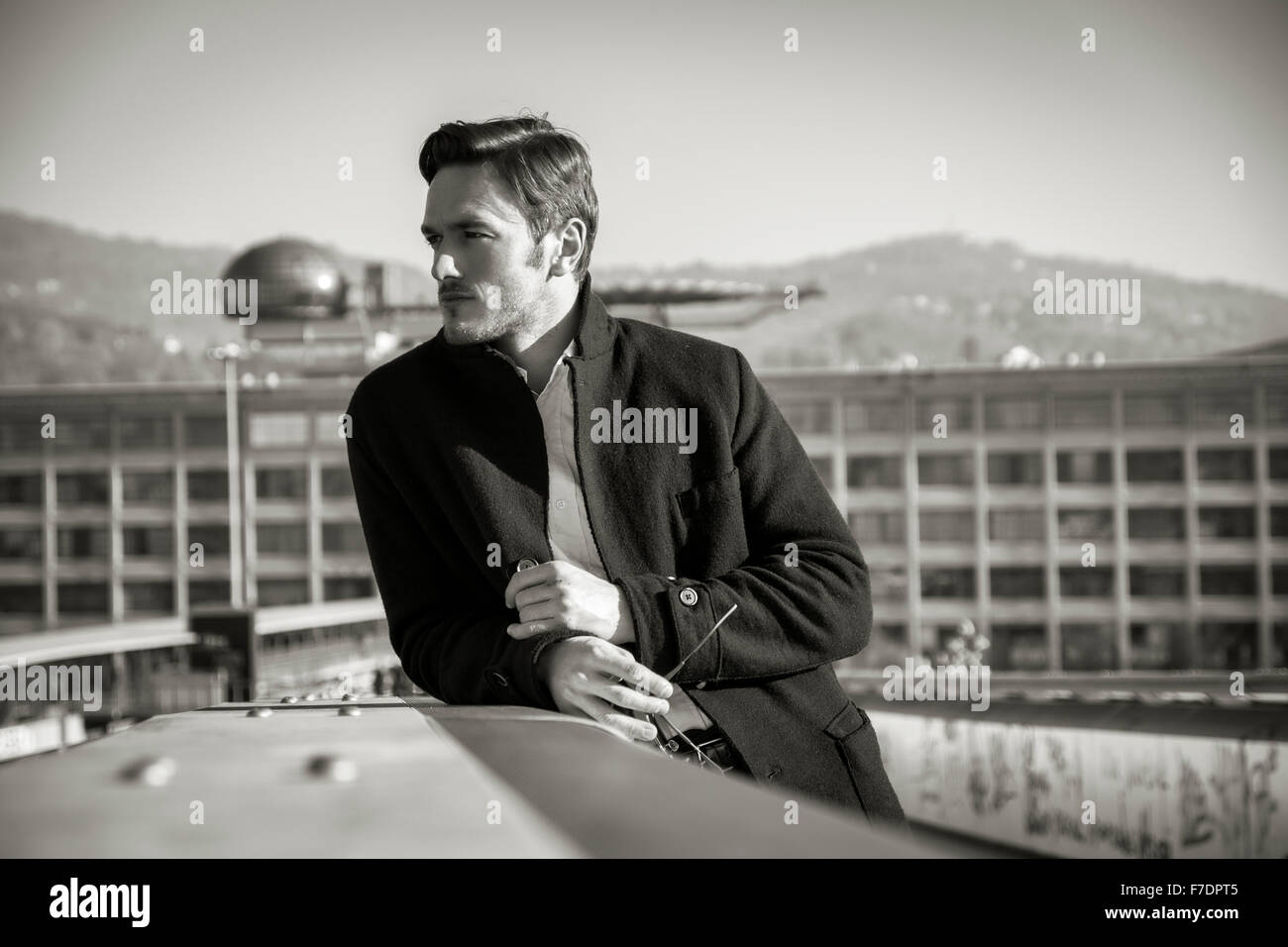 Handsome young man outdoor in winter fashion, wearing black coat and ...