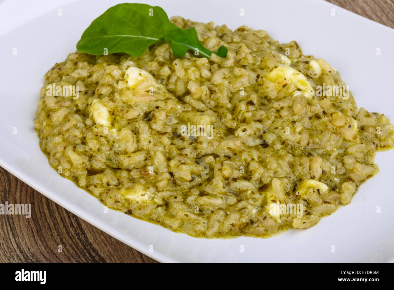 Risotto with pesto, ruccola leaf and soft cheese Stock Photo - Alamy