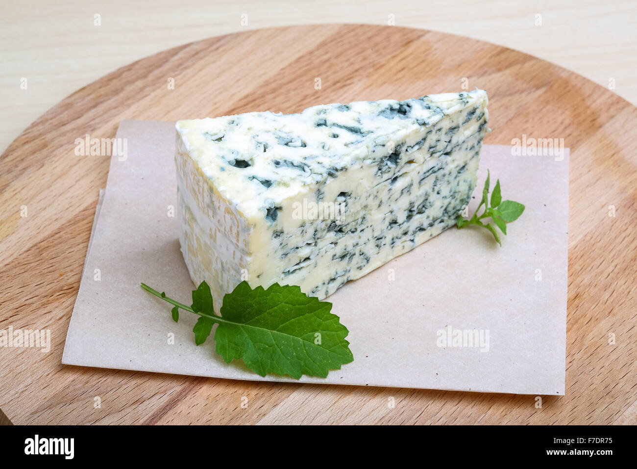 Dor Blue cheese with basil on the wood background Stock Photo - Alamy