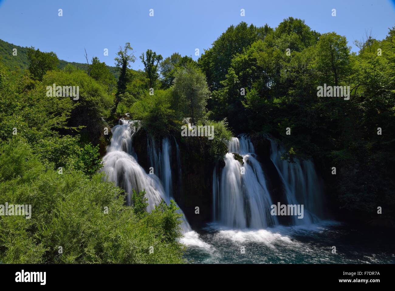waterfall with clean and fresh water nature with green forest in ...