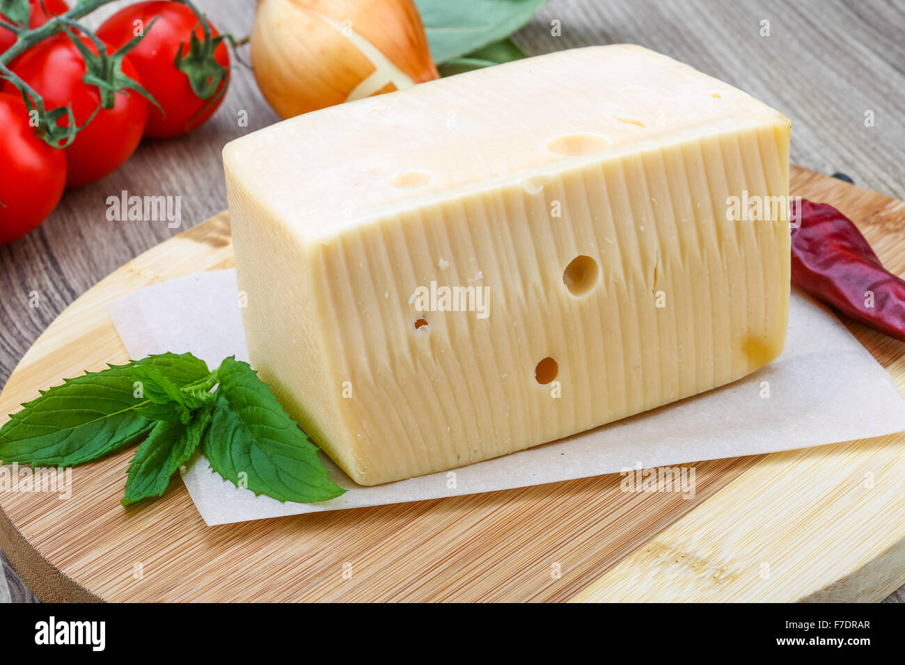 Yellow cheese brick with mint leaves on the wood background Stock Photo ...