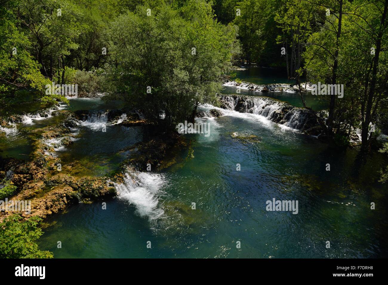 waterfall with clean and fresh water nature with green forest in ...