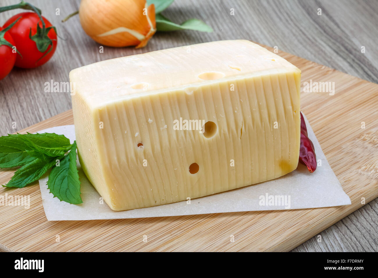 Yellow cheese brick with mint leaves on the wood background Stock Photo ...
