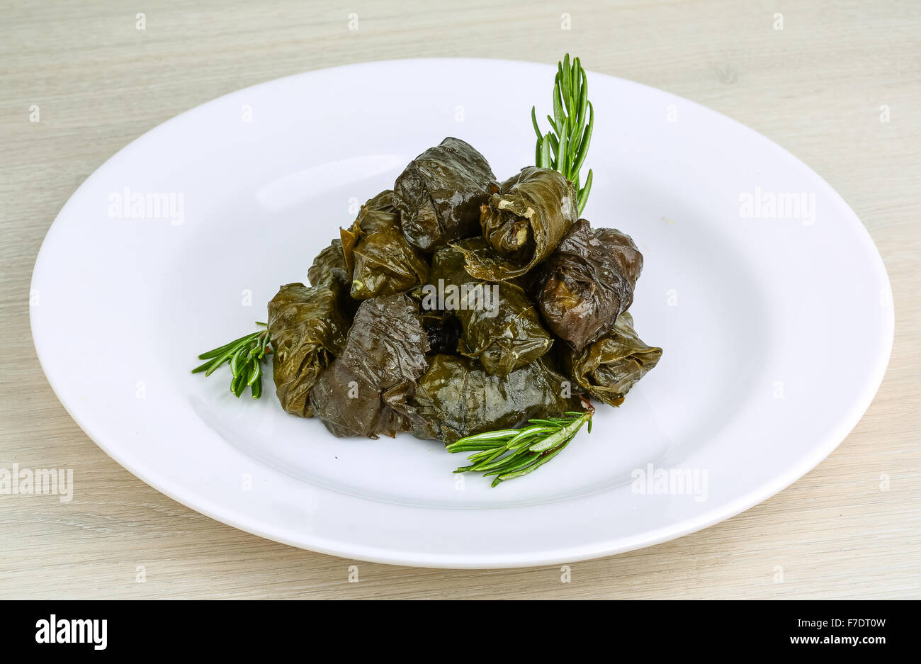 Greek dolma in grape leaves with meat served rosemary Stock Photo - Alamy