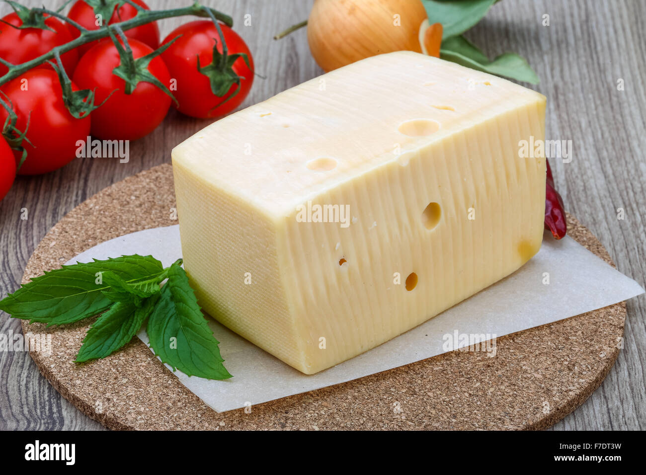 Yellow cheese brick with mint leaves on the wood background Stock Photo ...