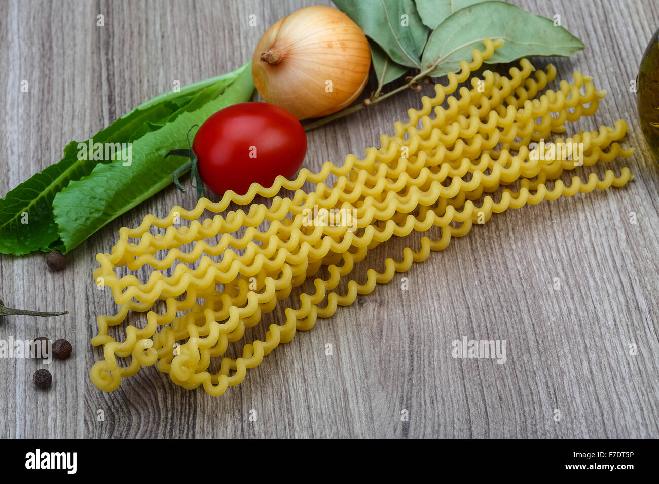 Long raw fusilli with olive oil and spices Stock Photo - Alamy