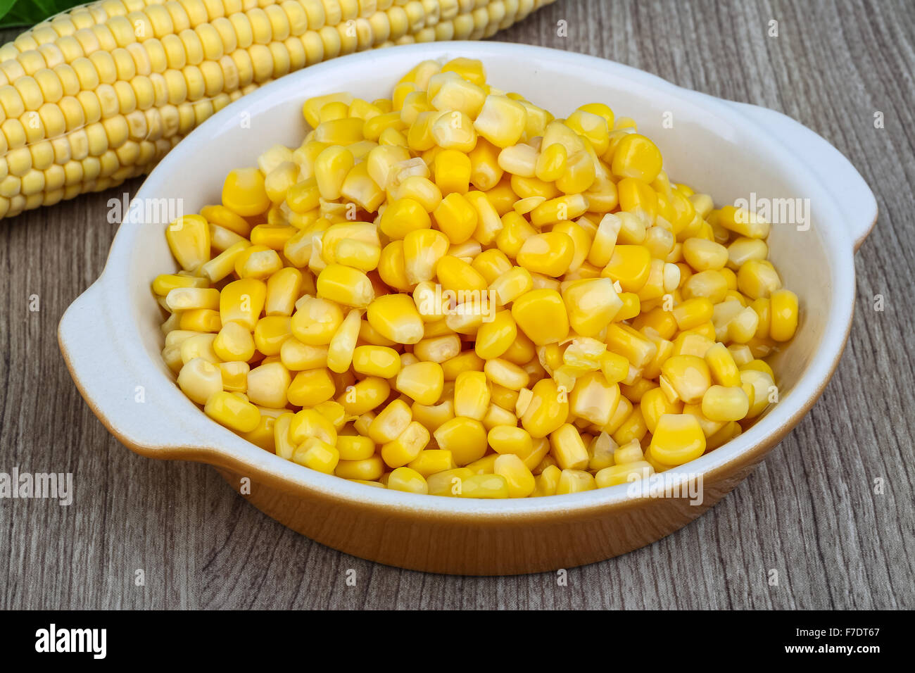 Sweet canned fresh corn on the wood background Stock Photo - Alamy