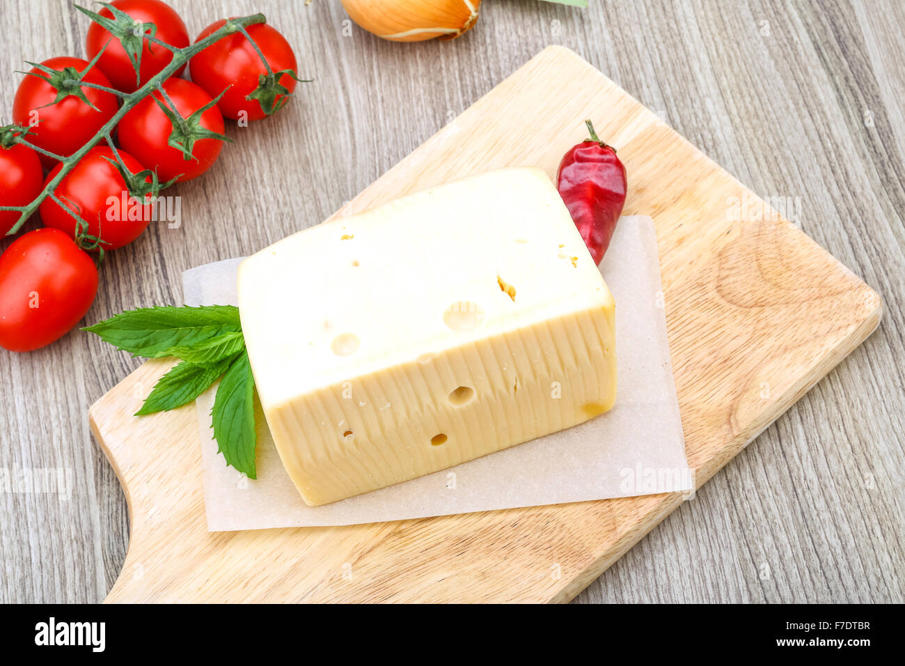 Yellow cheese brick with mint leaves on the wood background Stock Photo ...