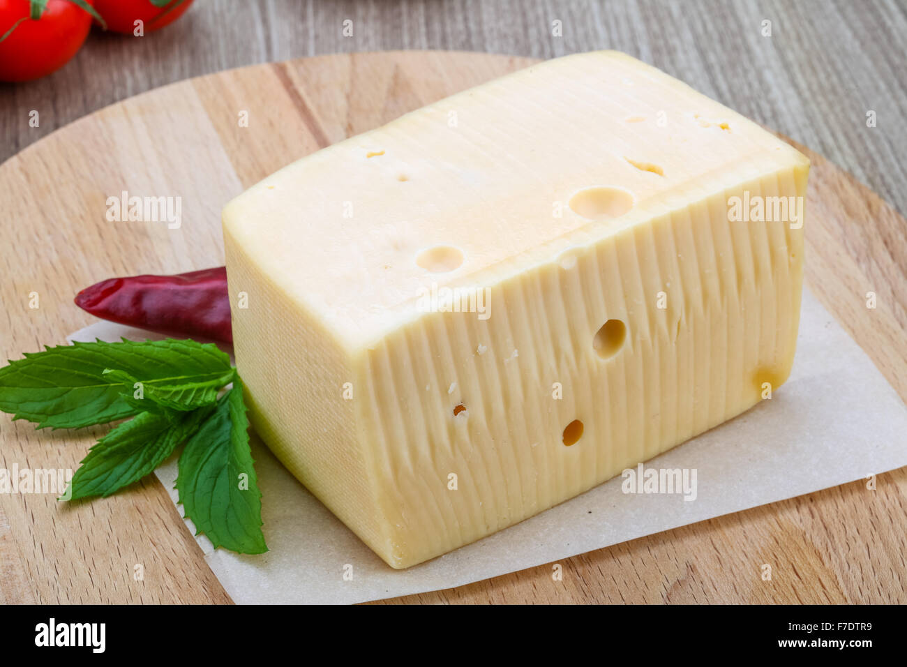 Yellow cheese brick with mint leaves on the wood background Stock Photo ...