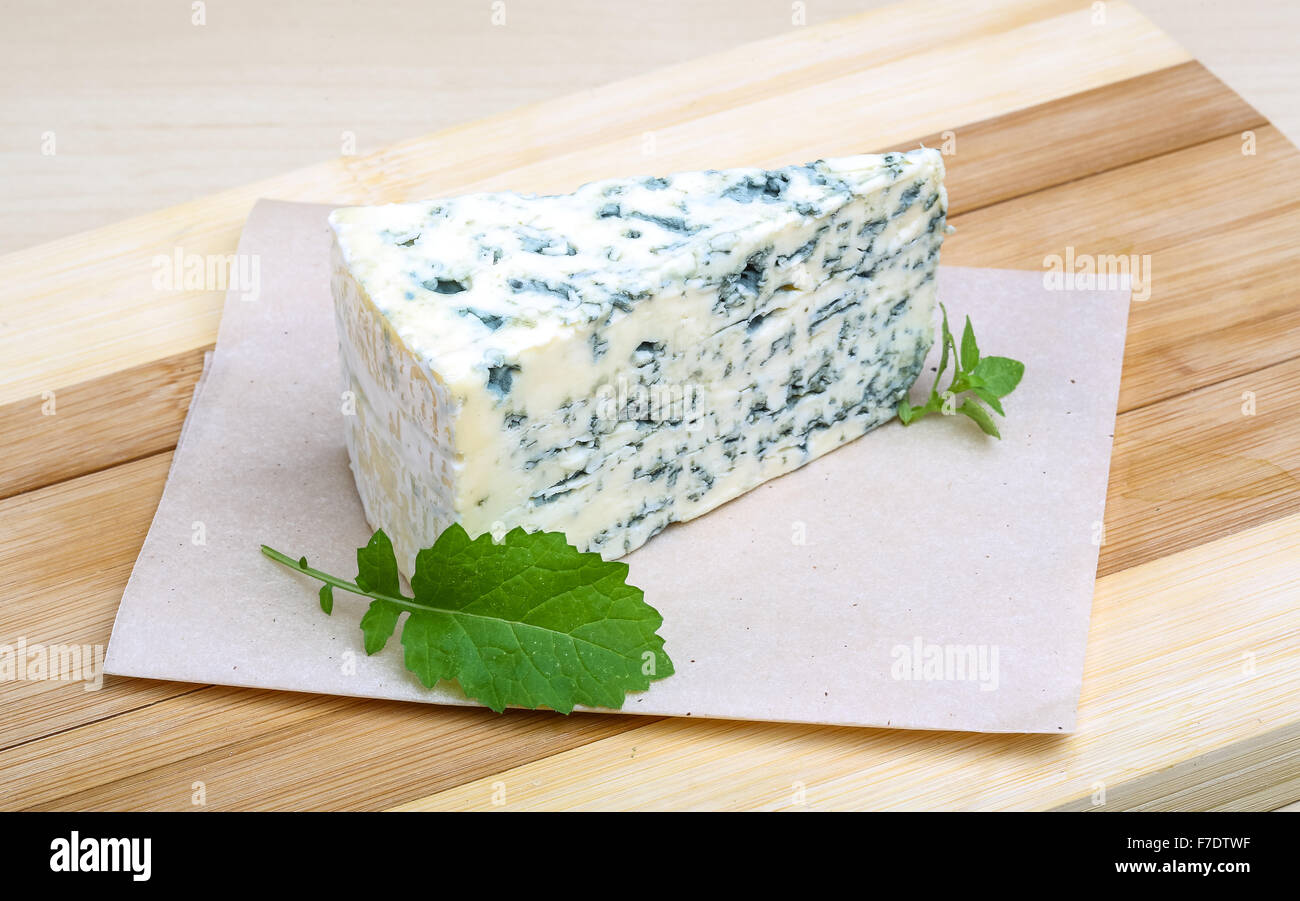 Dor Blue cheese with basil on the wood background Stock Photo - Alamy