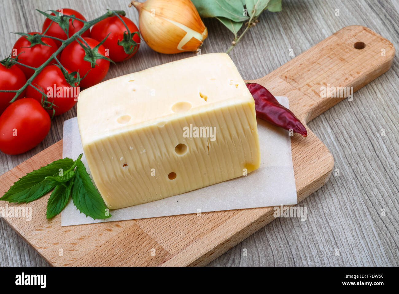 Yellow cheese brick with mint leaves on the wood background Stock Photo ...