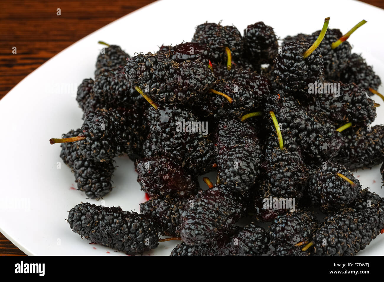 Fresh ripes Mulberry on the plate wood background Stock Photo - Alamy