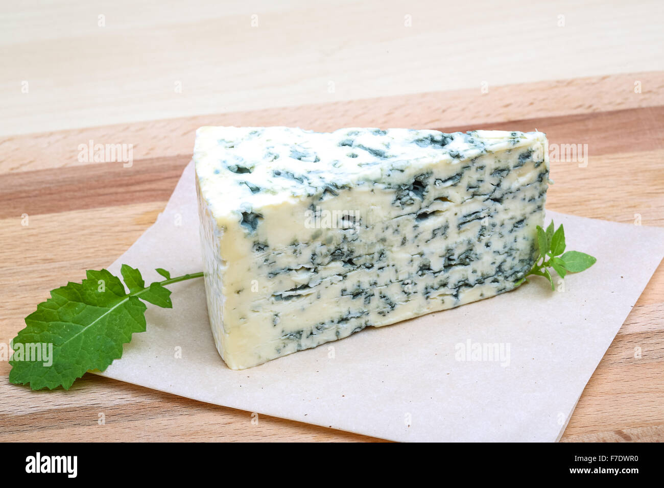 Dor Blue cheese with basil on the wood background Stock Photo - Alamy