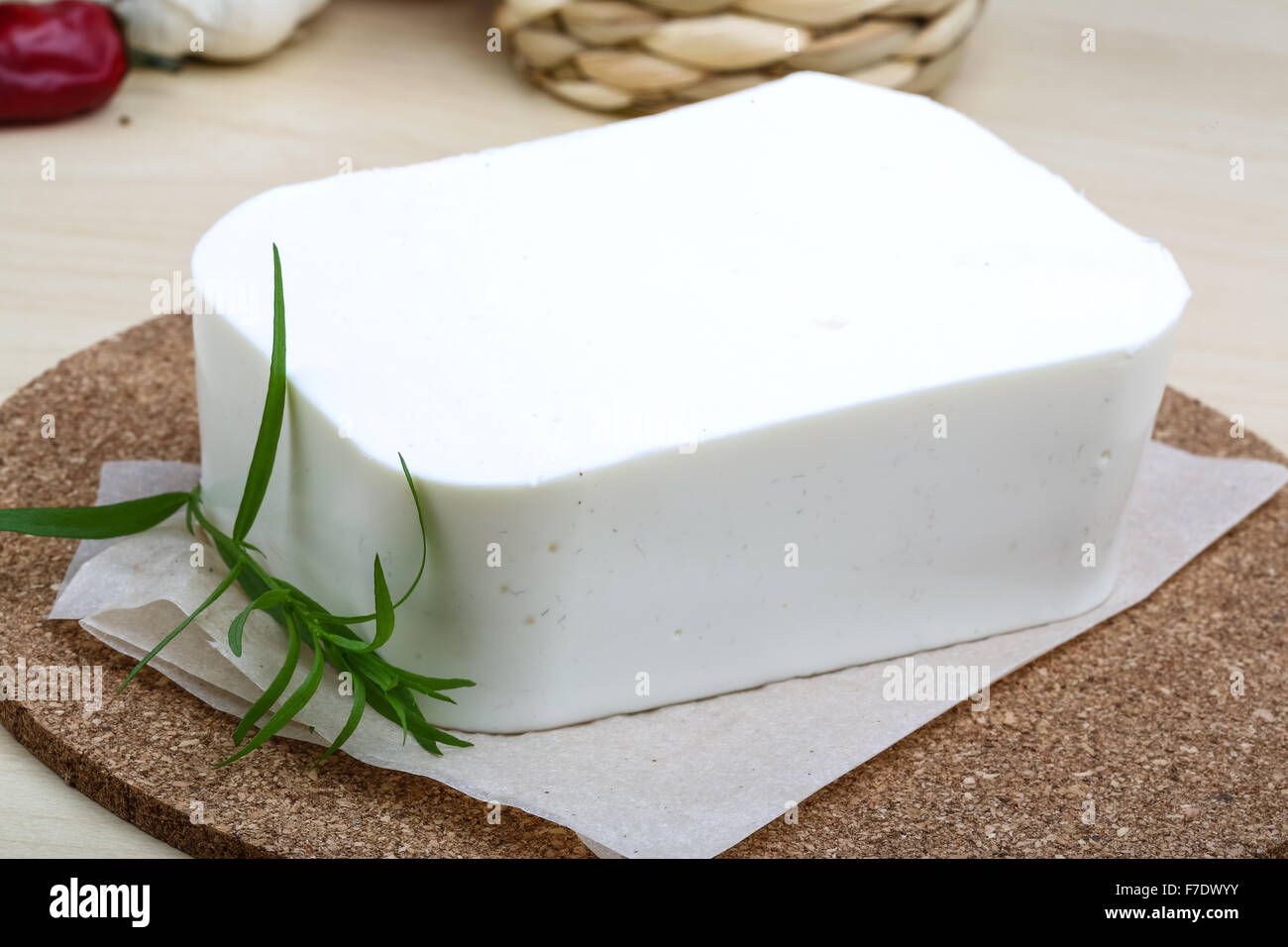 Feta cheese slice on the board with terragon Stock Photo - Alamy