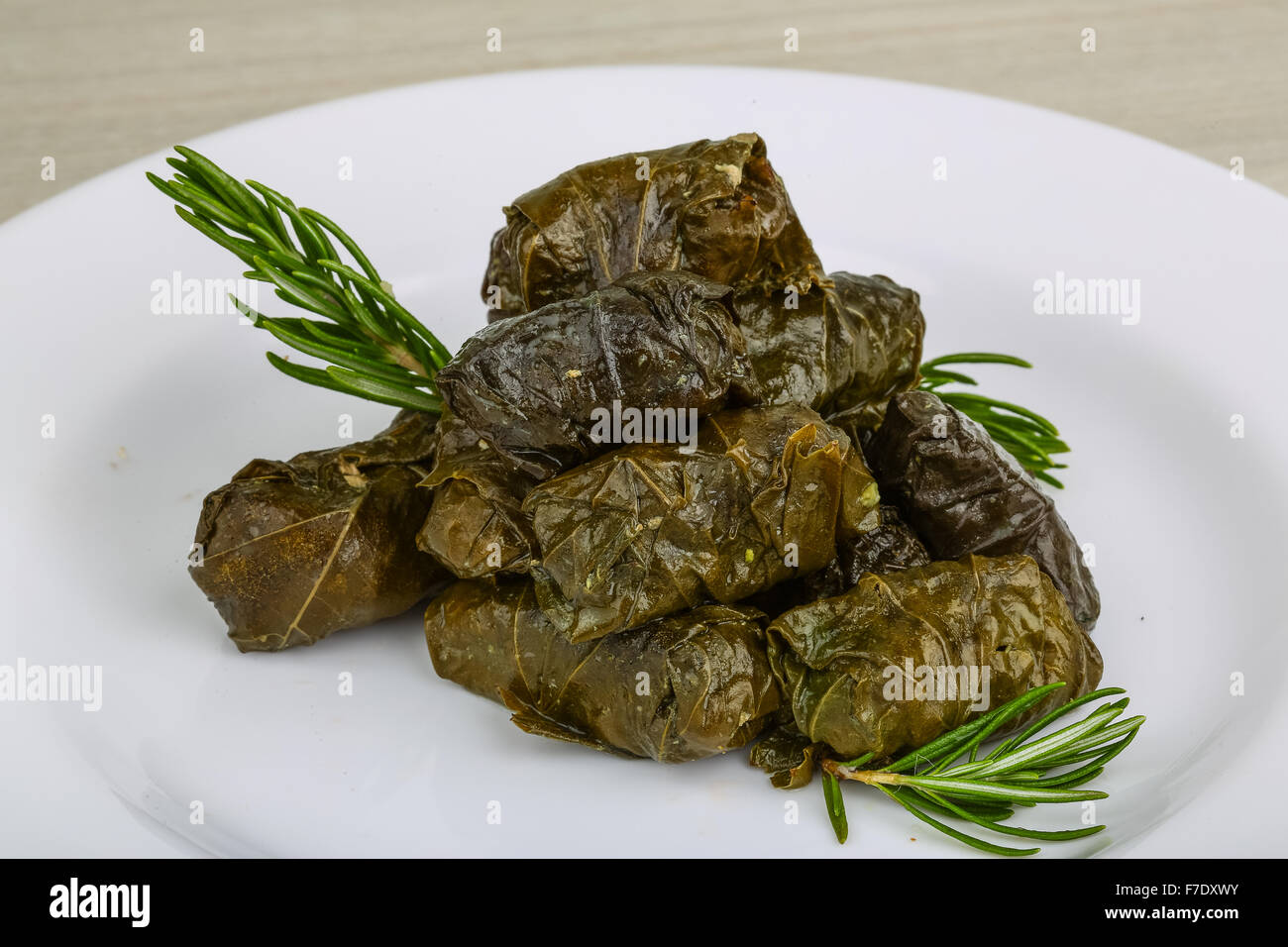 Greek dolma in grape leaves with meat served rosemary Stock Photo - Alamy
