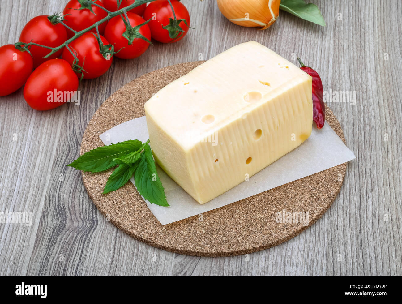 Yellow cheese brick with mint leaves on the wood background Stock Photo ...