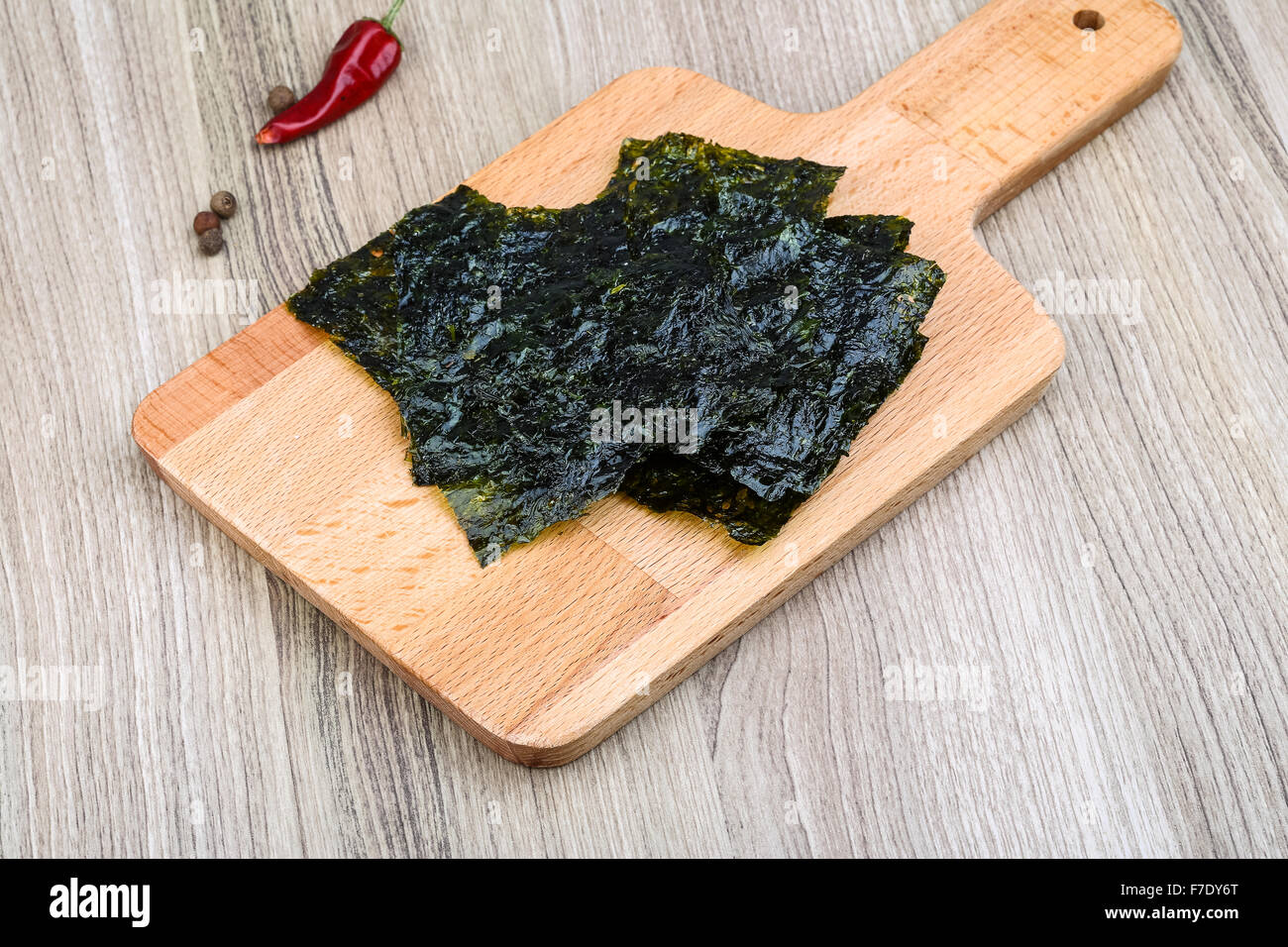 Korean traditional snack - Nori seaweed sheets on the wood background ...