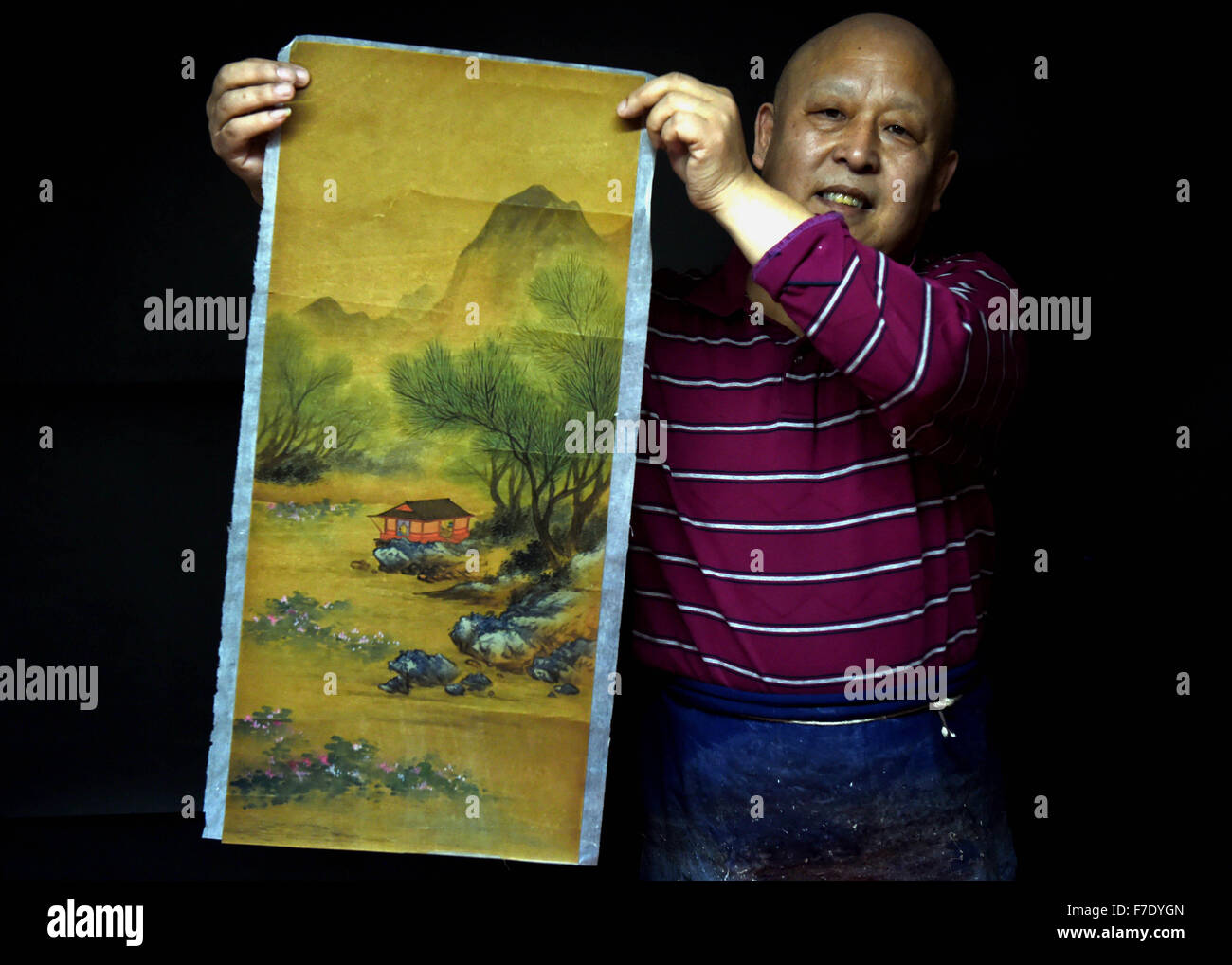 Beijing, China. 29th Nov, 2015. Artist Wang Yuwei shows the ancient ...