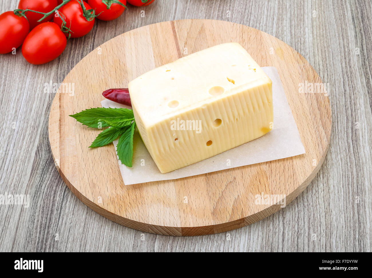 Yellow cheese brick with mint leaves on the wood background Stock Photo ...
