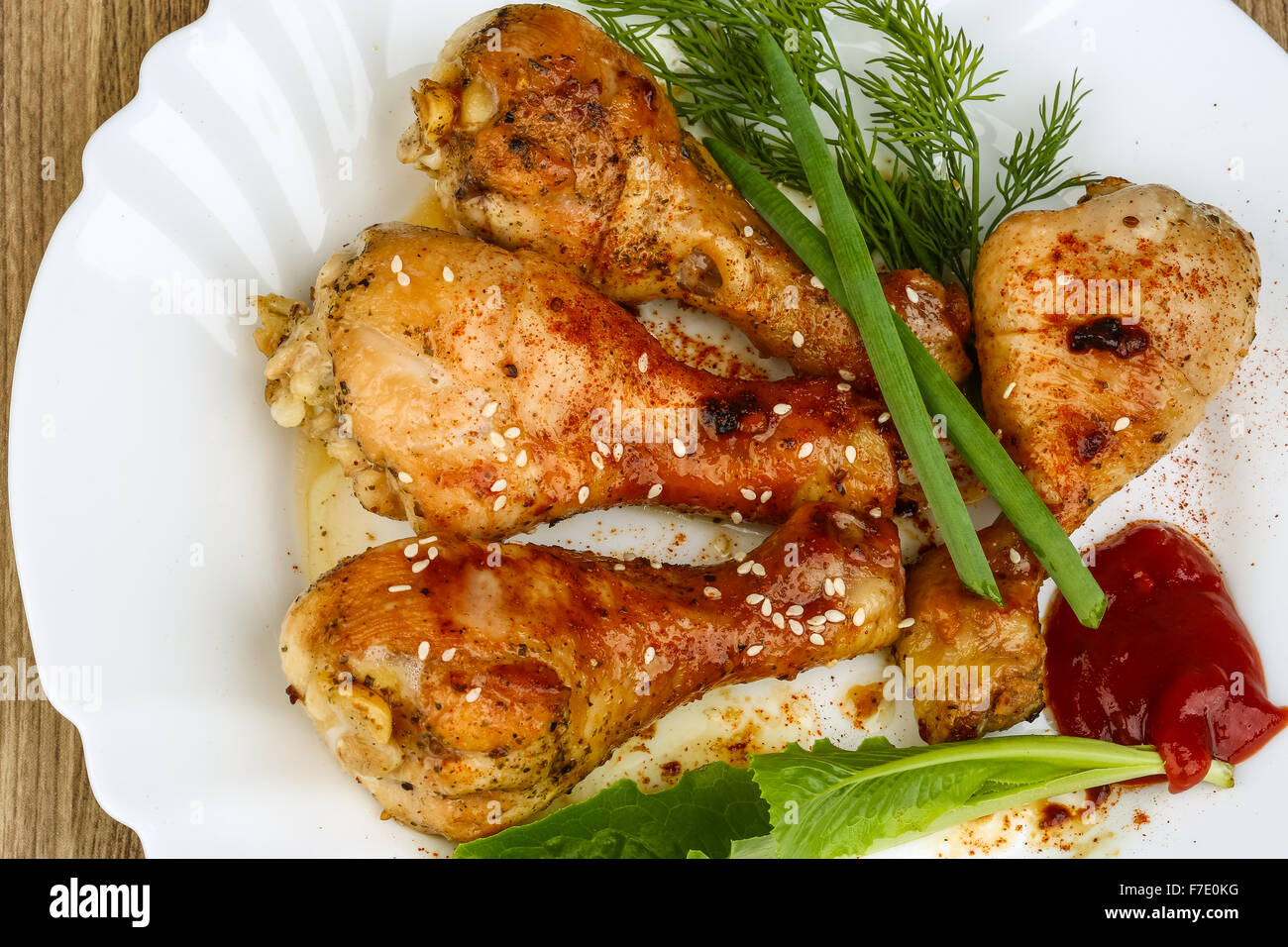 Grilled chicken legs with sesame seeds, dill and green onion Stock ...