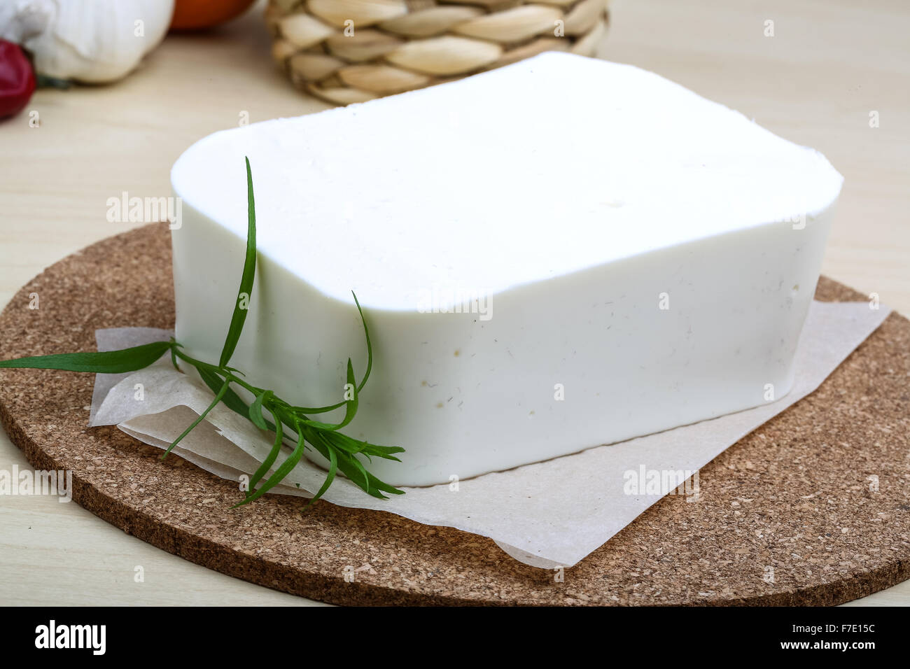 Feta cheese slice on the board with terragon Stock Photo - Alamy