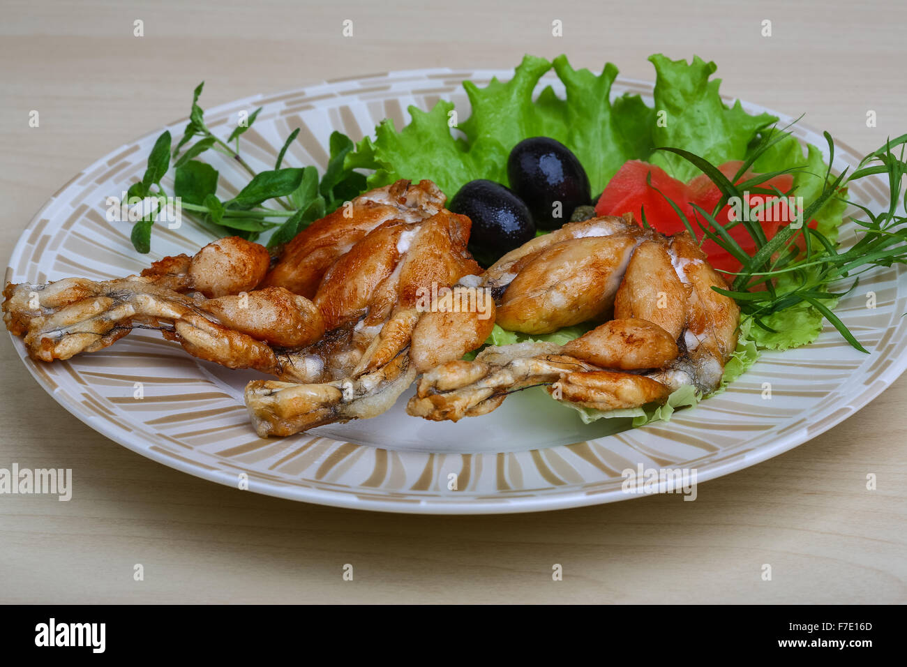 Roasted Frog legs with herbs and spices Stock Photo - Alamy