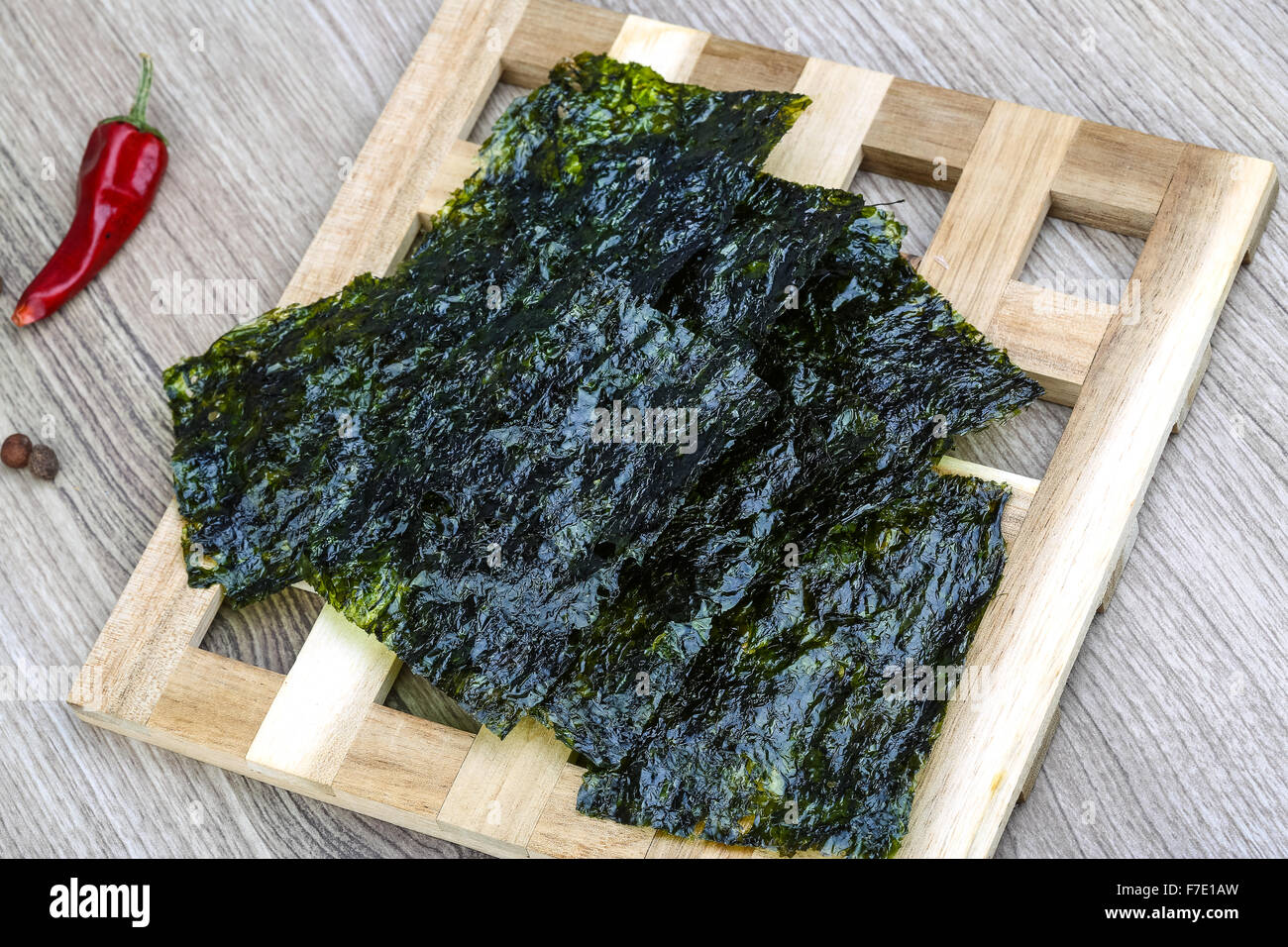 Korean traditional snack - Nori seaweed sheets on the wood background ...