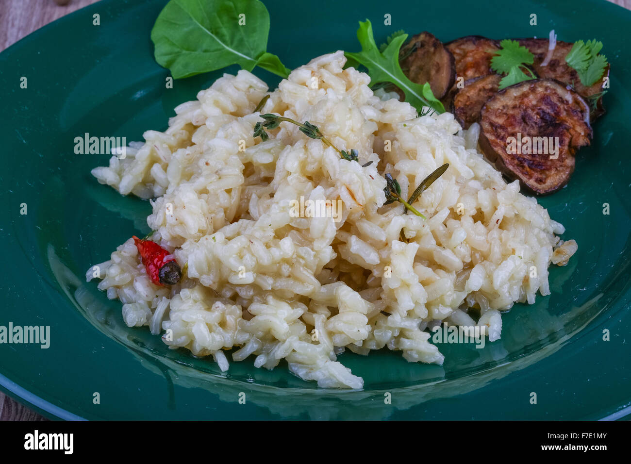 Italian trditional Risotto with eggplant and coriander Stock Photo - Alamy
