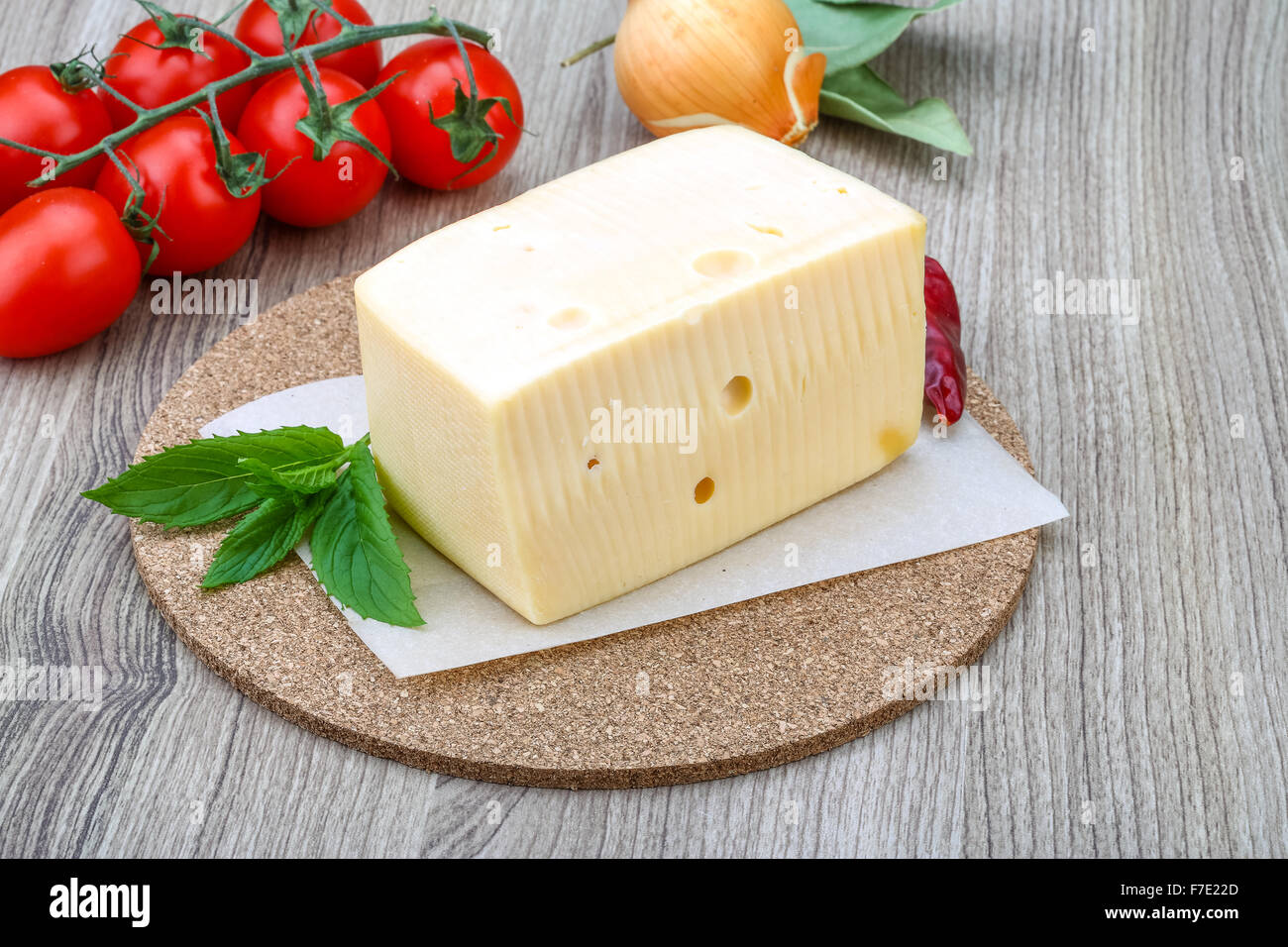 Yellow cheese brick with mint leaves on the wood background Stock Photo ...