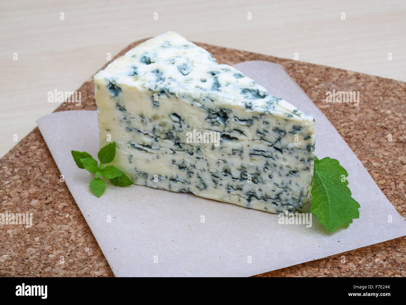 Dor Blue cheese with basil on the wood background Stock Photo - Alamy