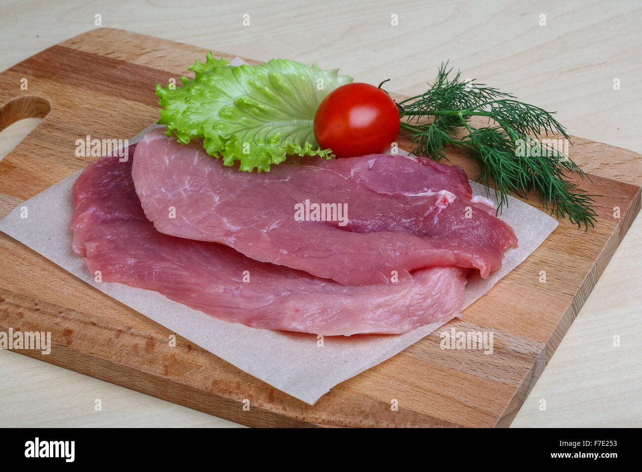 Raw pork schnitzel with dill - ready for cooking Stock Photo - Alamy