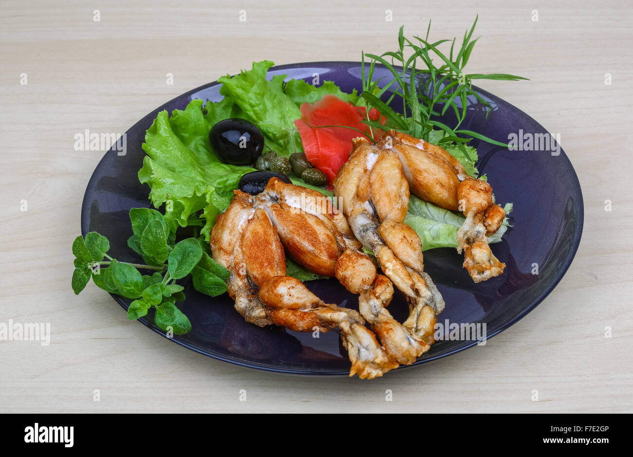 Roasted Frog legs with herbs and spices Stock Photo - Alamy