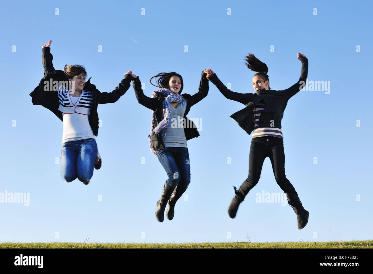 group of teen people woman have fun outdoor with blue sky in background ...