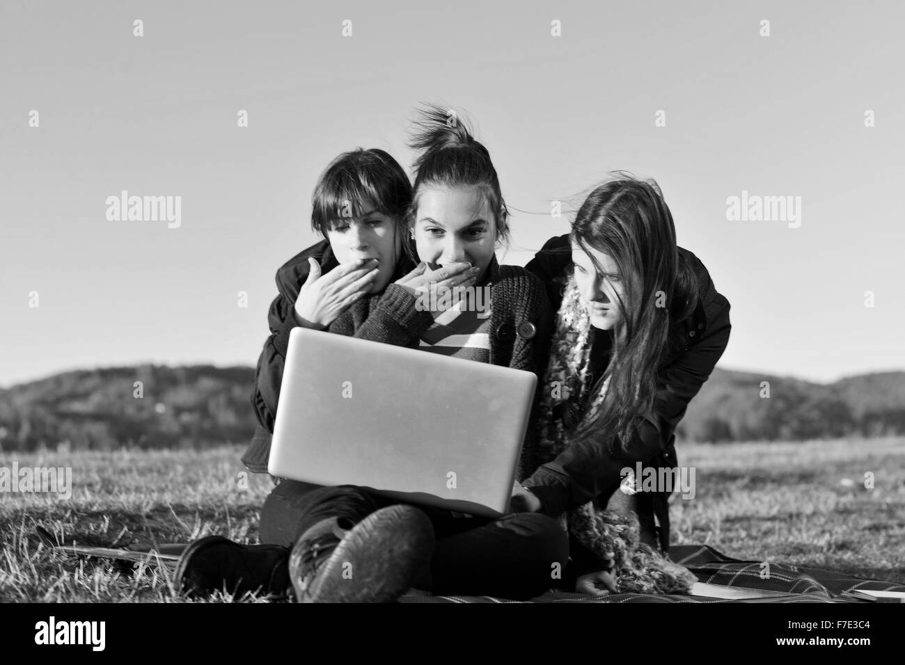 group of teen girl woman outdoor have fun and study homework on laptop ...