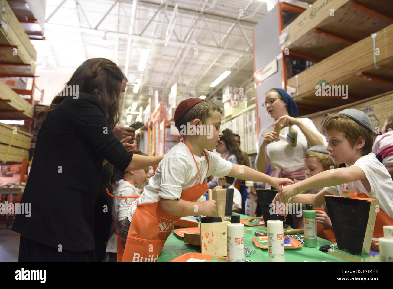 Reaching across the table during work. Friendship Circle of Brooklyn ...