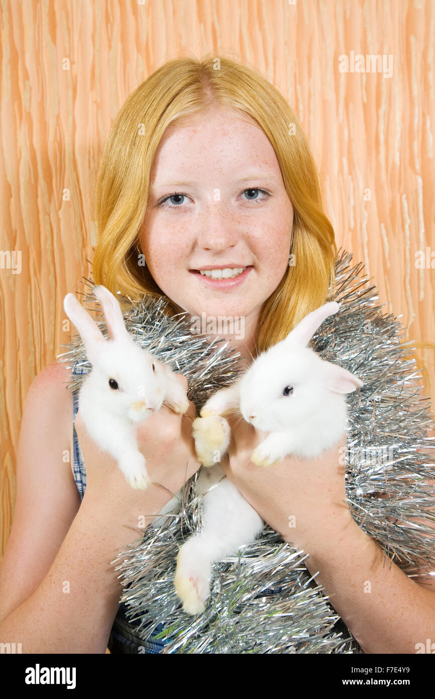 teen girl in peddlery with two pet rabbits Stock Photo - Alamy