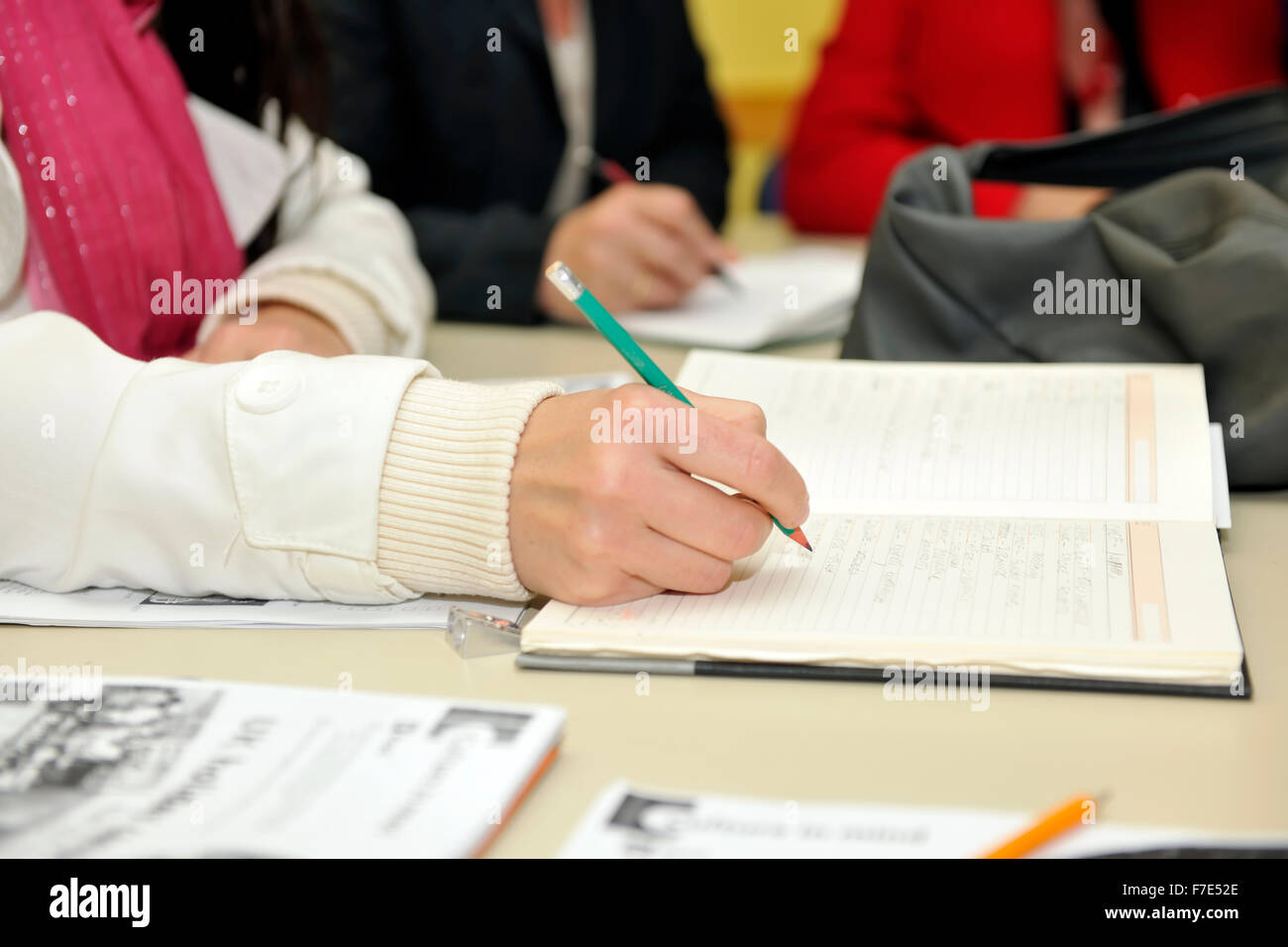 education concept with students who taking notes and learning lessons ...