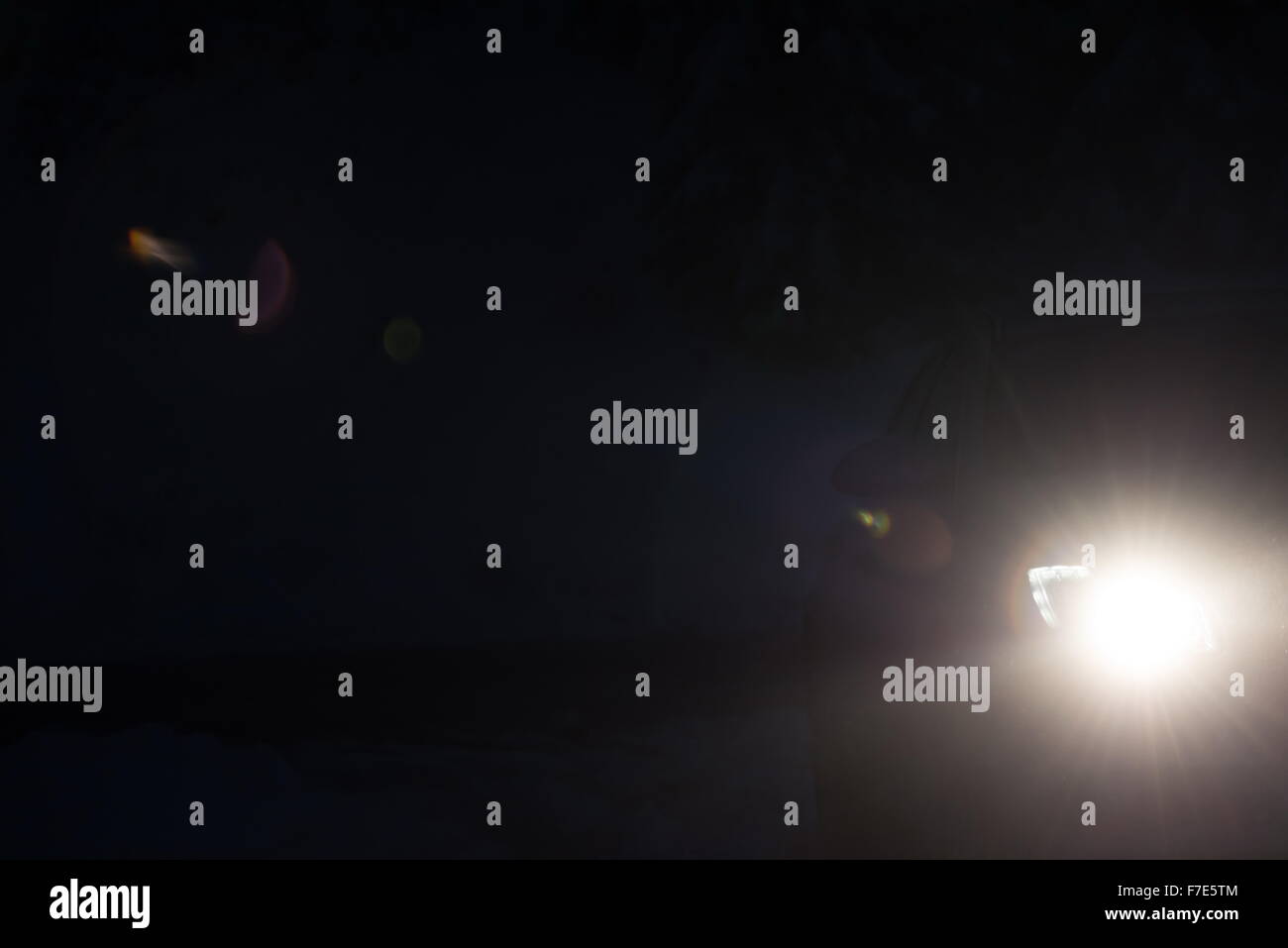 driving car in night, modern front lights lens flare in black ...