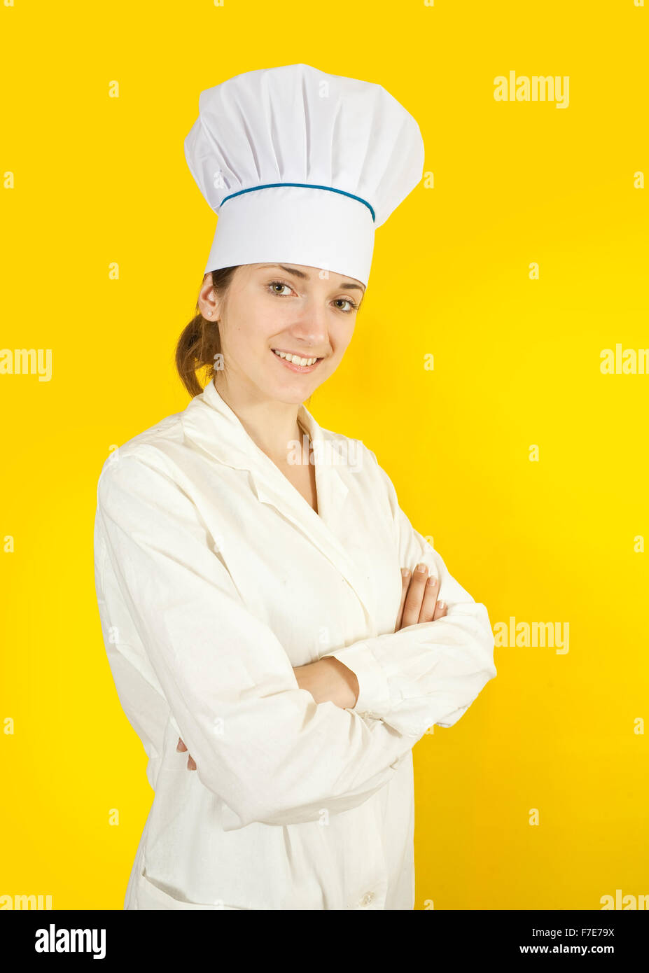 Female cook in toque over yellow background Stock Photo - Alamy
