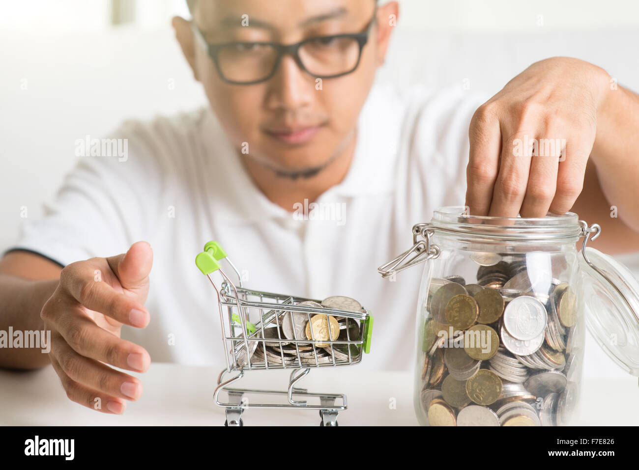 asian male saving money Stock Photo - Alamy